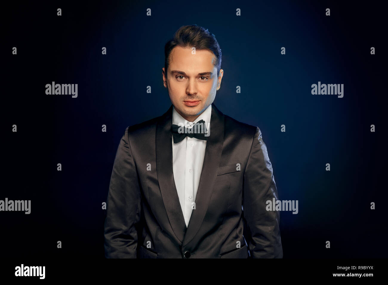 Professional showman wearing suit standing isolated on black background ...