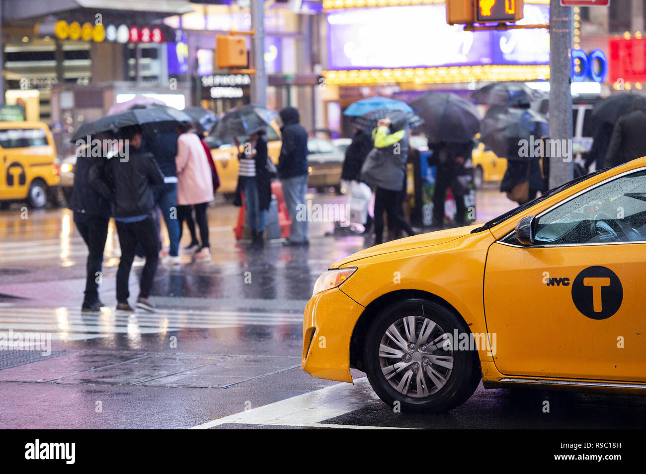 Yellow cab speeds through Times Square, the busy tourist intersection ...