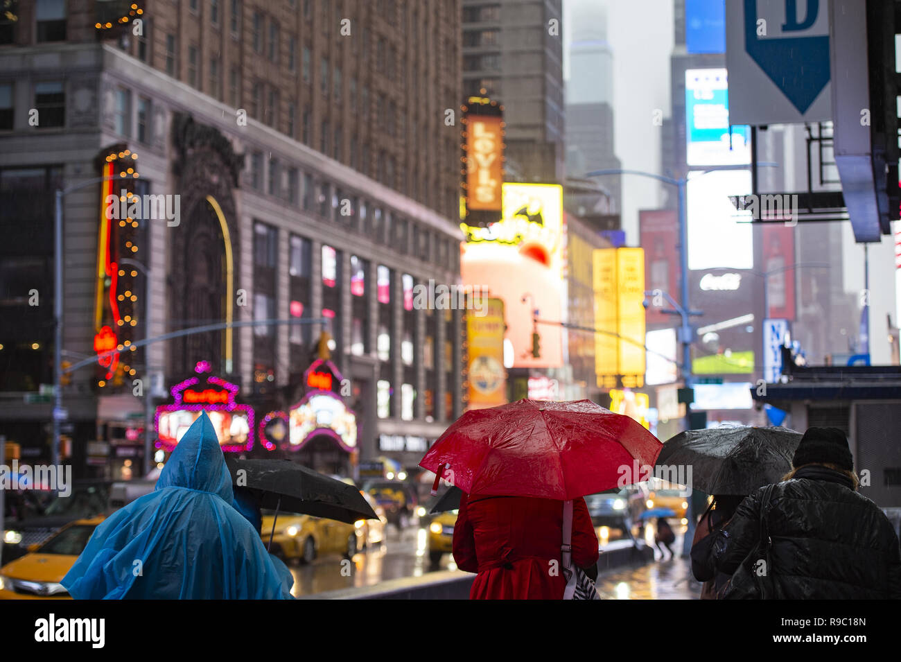 Local people and tourists walk with their umbrellas during a rainy day ...