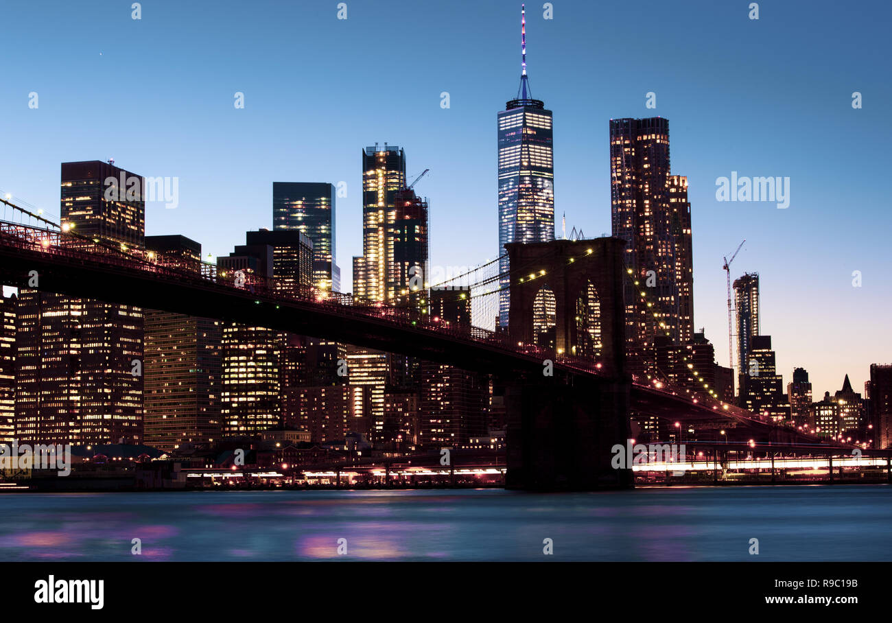 Beautiful Brooklyn Bridge and the illuminated Manhattan's skyline at ...