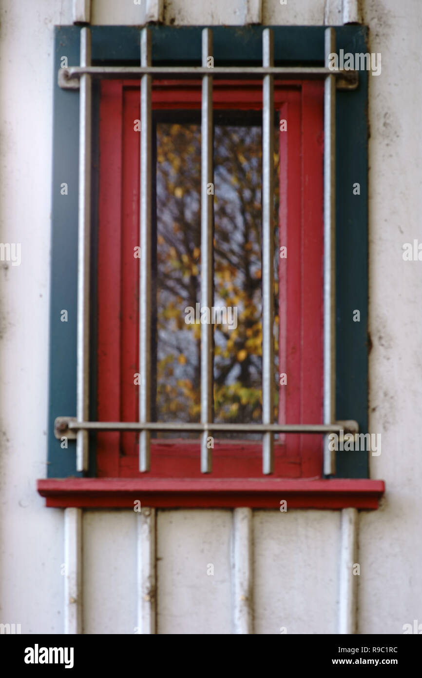 A barred window to the office of a goods reception at an industrial ...