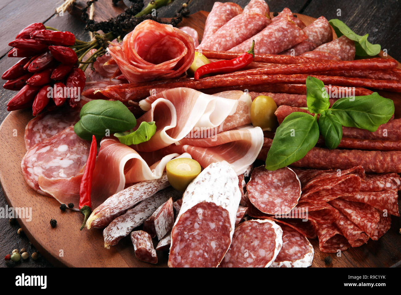 Food tray with delicious salami, pieces of sliced prosciutto crudo ...