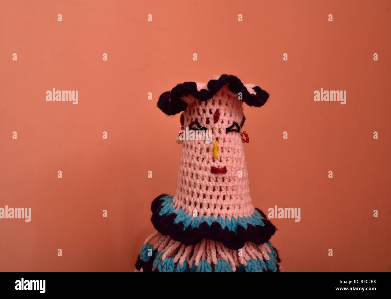 Knitting woolen doll with beautiful pink background Stock Photo - Alamy
