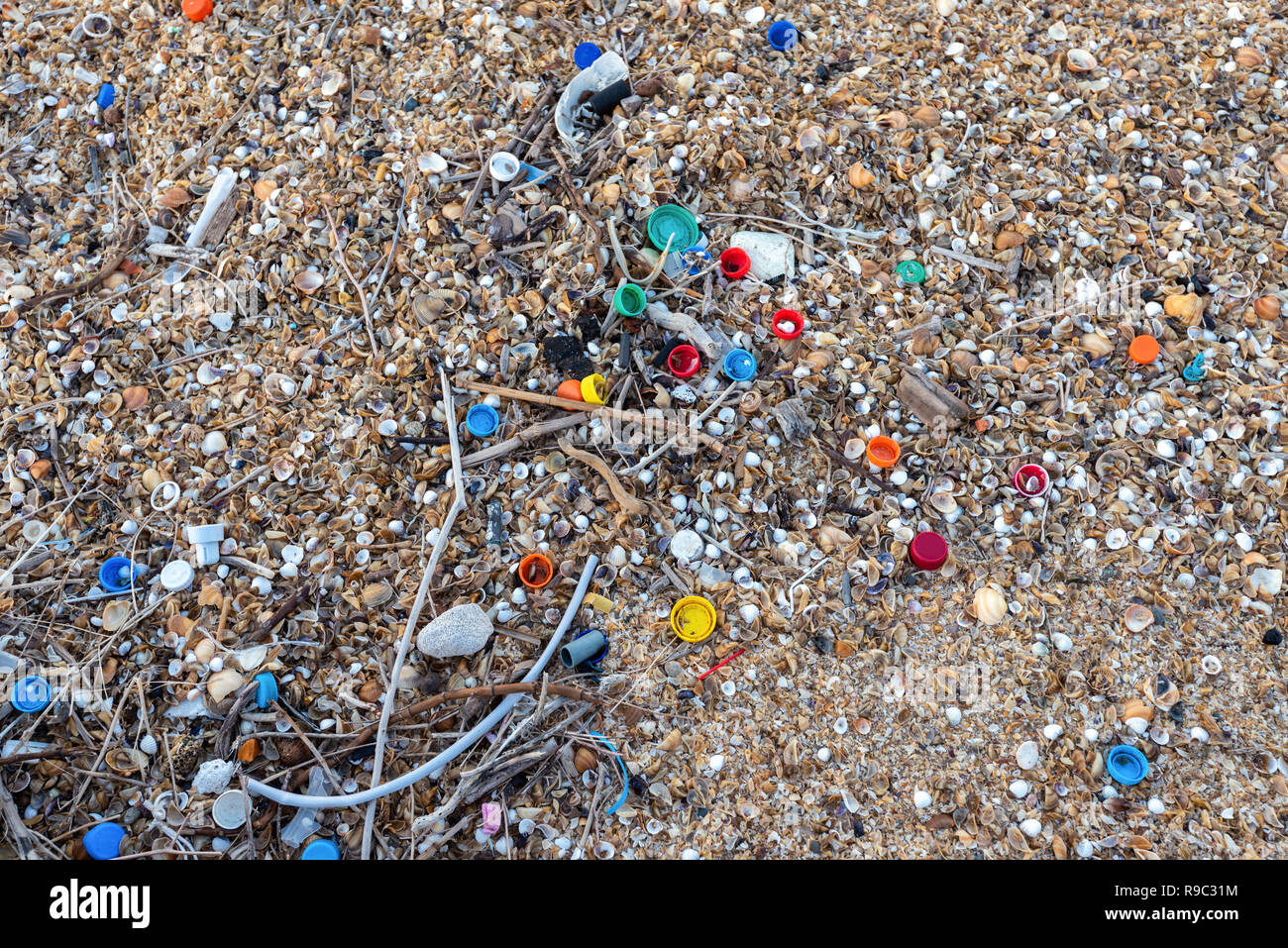 Plastic bottle caps scattered on the beach, environmental pollution ...