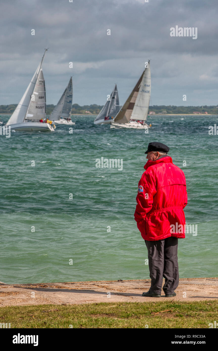Old man watching yachts racing in The Solent, Round The Island Race ...