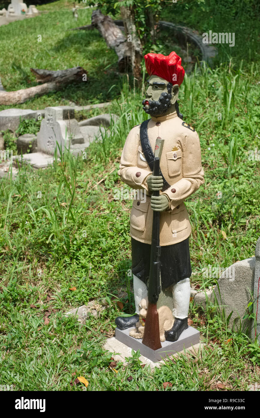 The figure of Sikh soldiers stands guard at a Chinese grave in Bukit ...