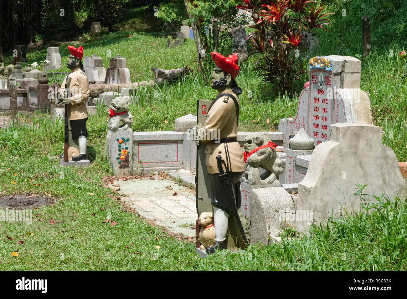 Figures of Sikh soldiers stand guard at a Chinese grave in Bukit Brown ...