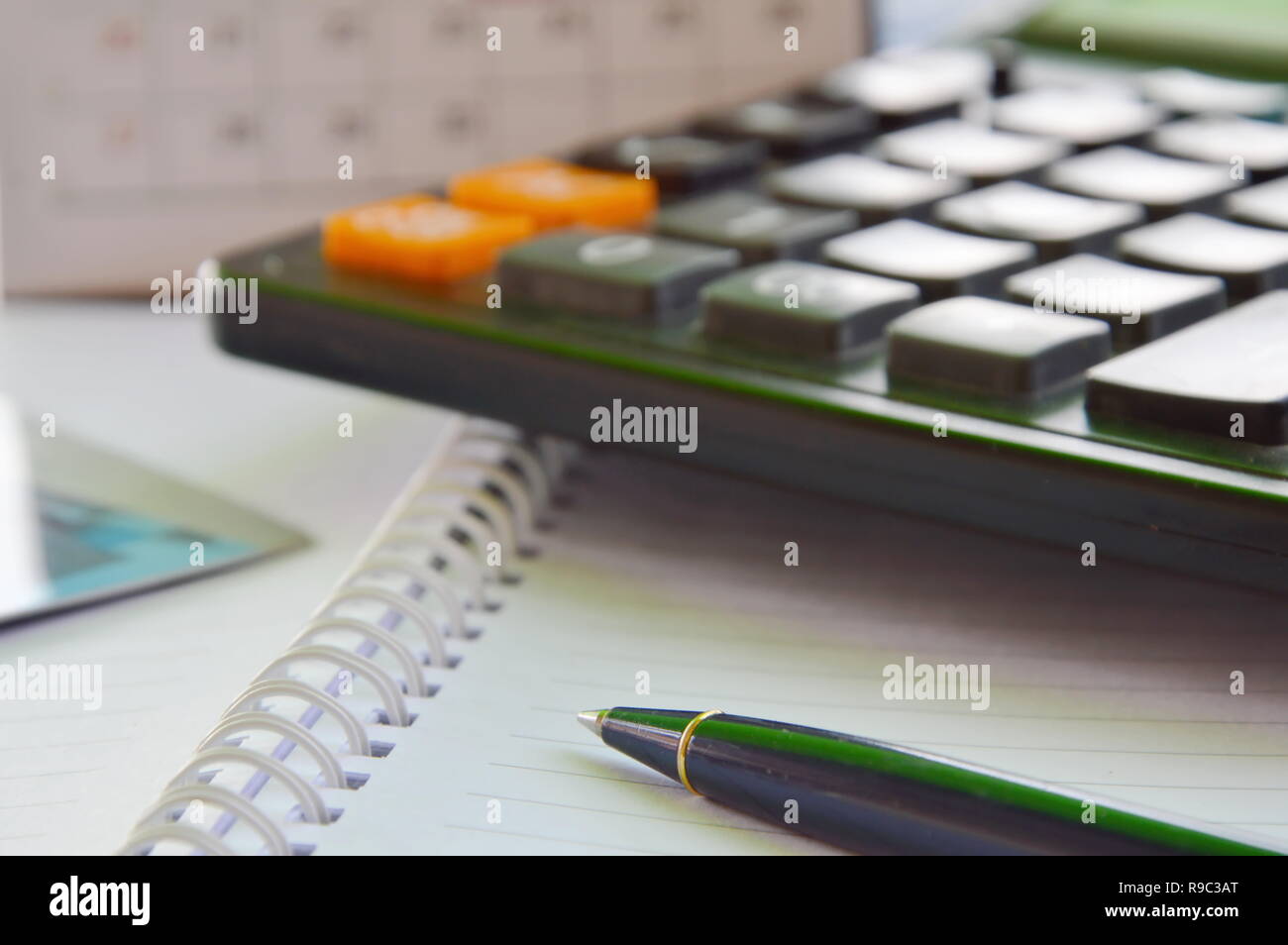 pen and calculator on the book Stock Photo - Alamy