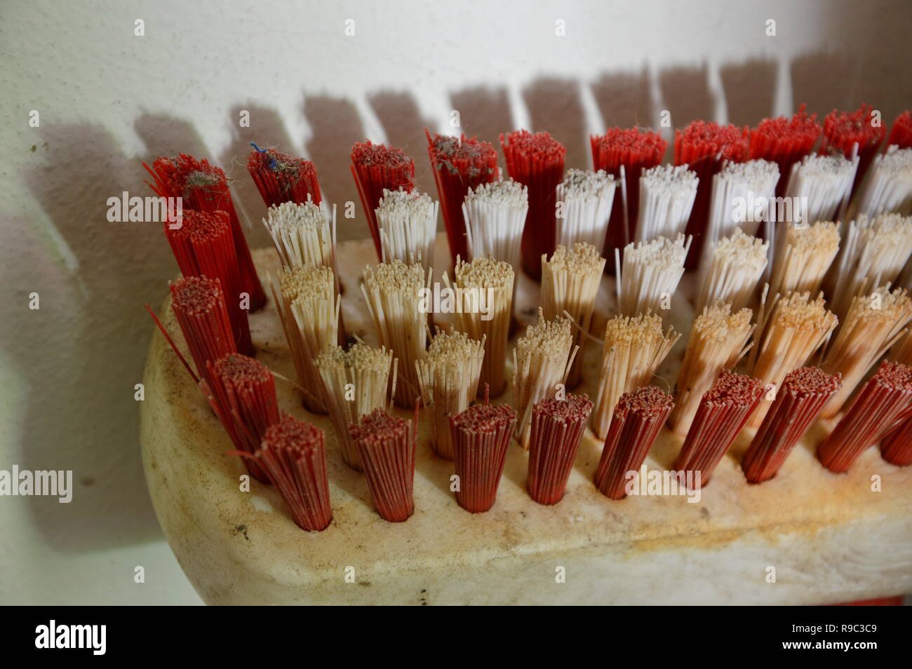 floor brush with red long handle leaning on bathroom wall Stock Photo ...