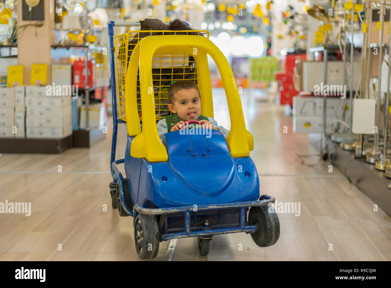 boy in a trolley at an industrial store Stock Photo - Alamy