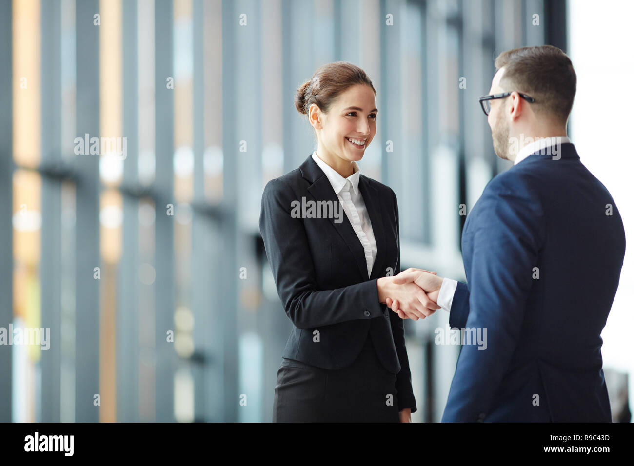 Handshaking with partner Stock Photo - Alamy