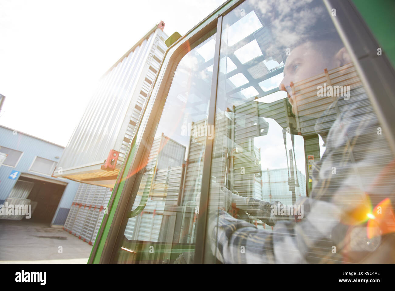 Loader man in machine Stock Photo - Alamy