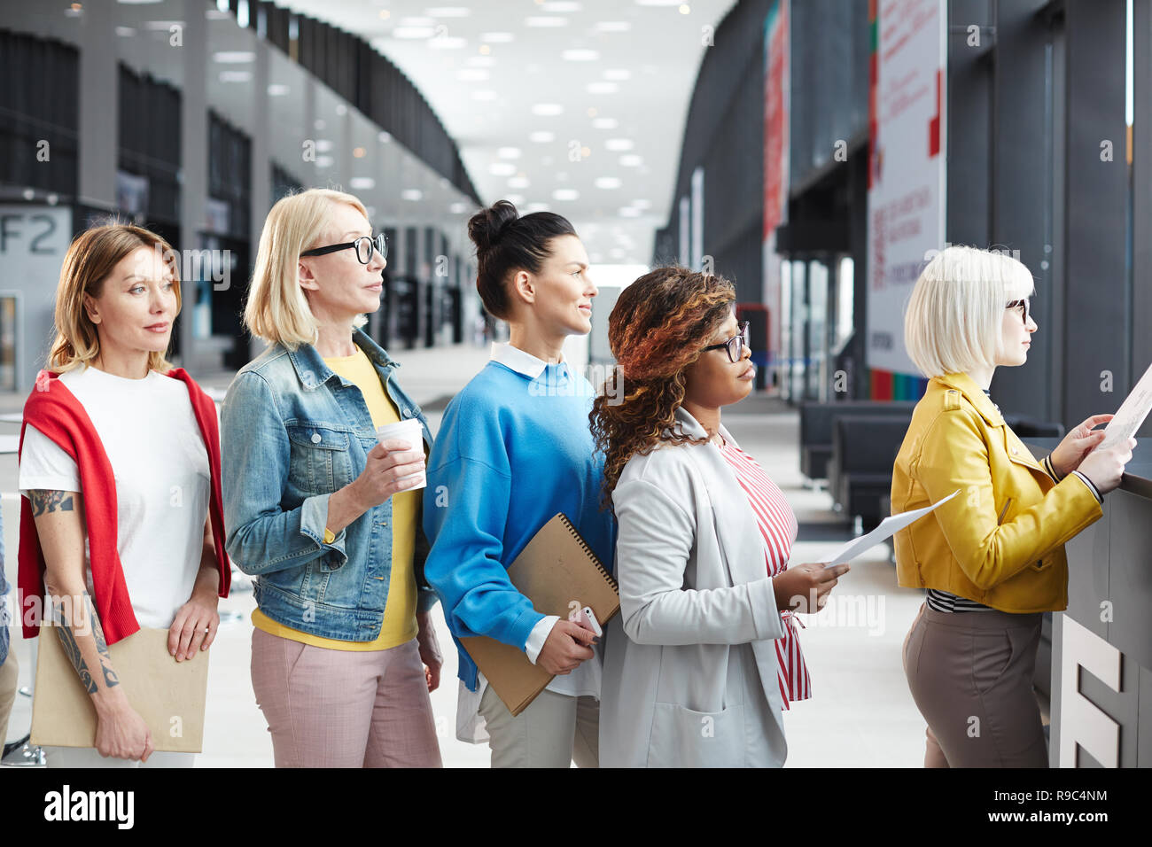 Business guests standing in line Stock Photo - Alamy