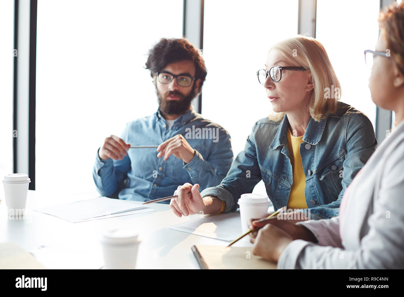 Business colleagues sharing ideas at meeting Stock Photo - Alamy
