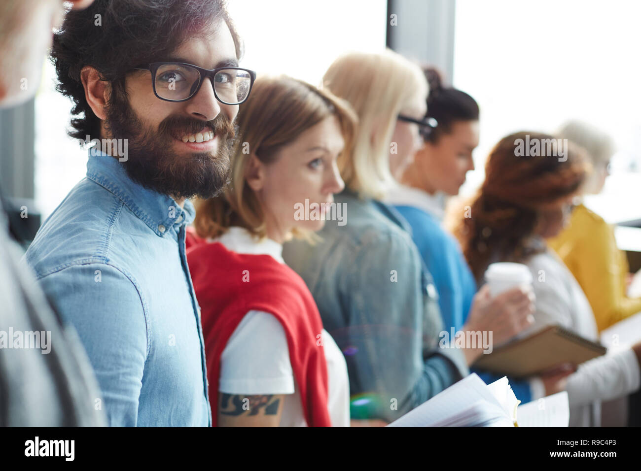 Happy excited man waiting turn in line Stock Photo - Alamy