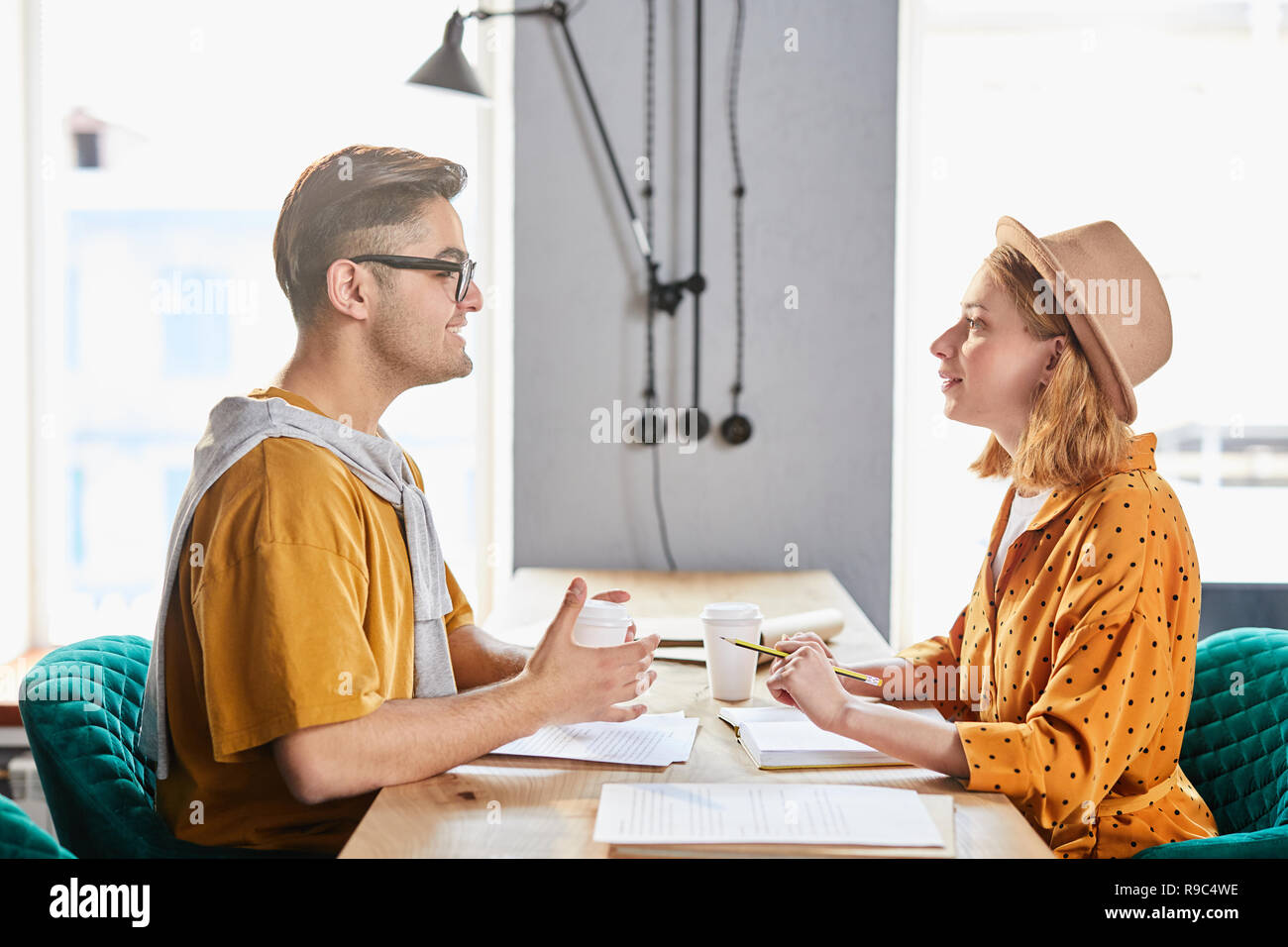 Young employees talking hi-res stock photography and images - Alamy