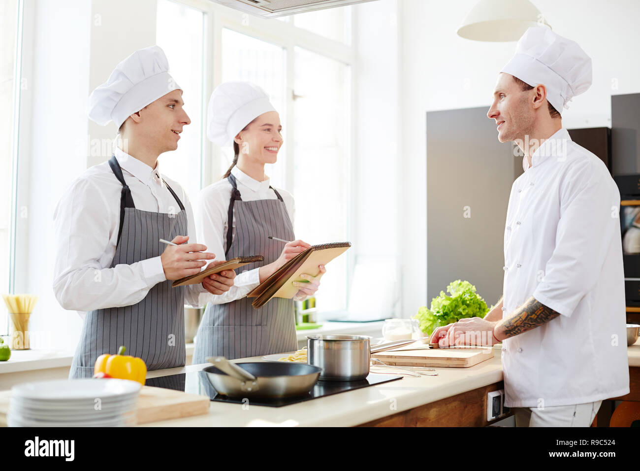 Listening to chef advice Stock Photo - Alamy