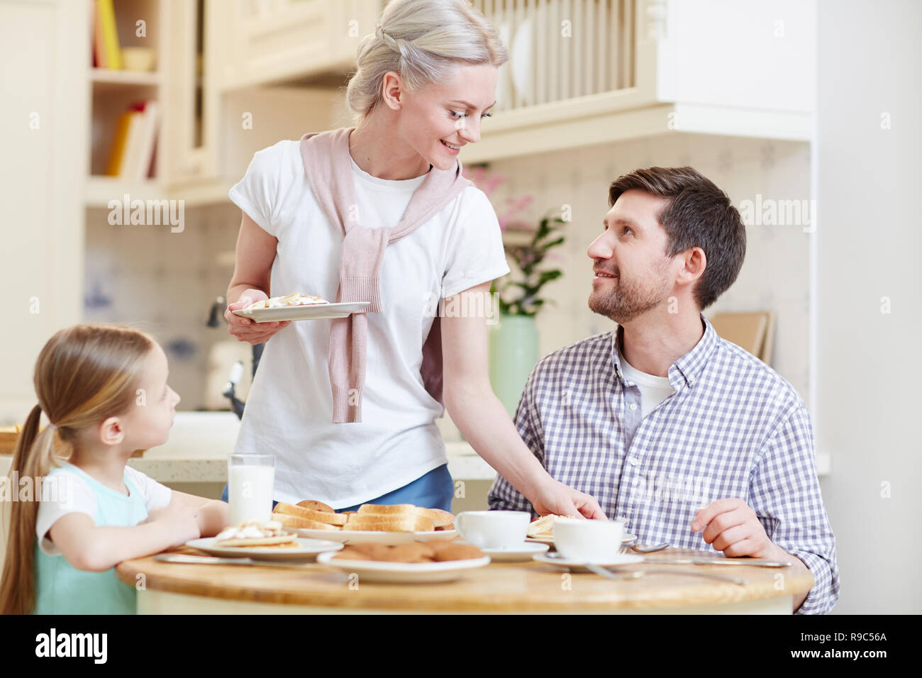 Giving food to husband Stock Photo - Alamy