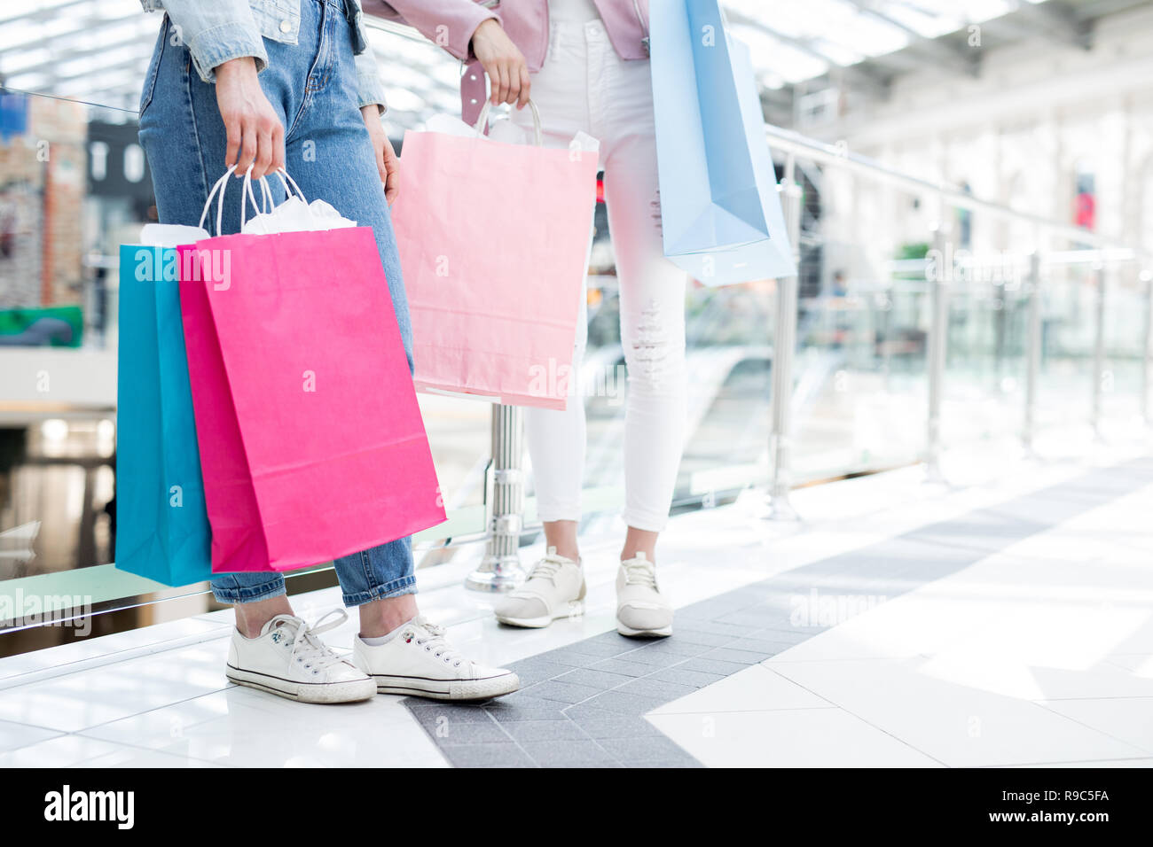 Girls with colorful shopping bags Stock Photo - Alamy