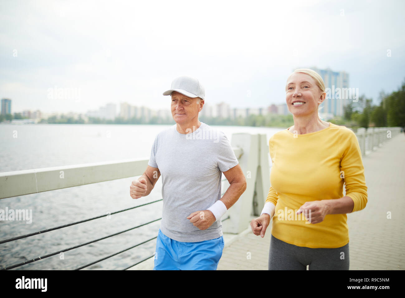 Aged couple jogging Stock Photo - Alamy