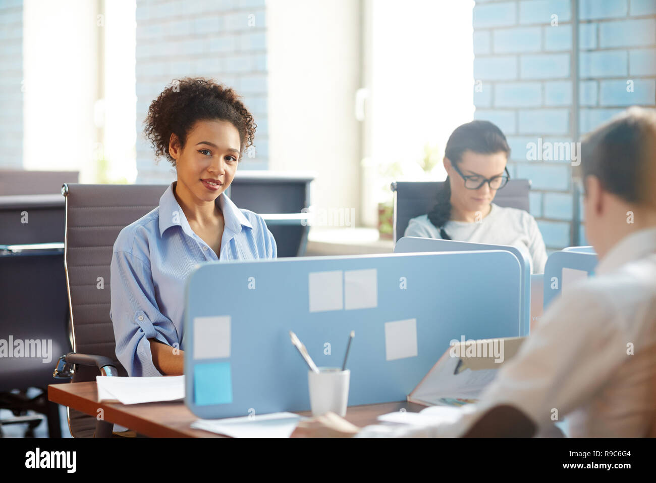 Happy young intercultural colleagues hi-res stock photography and ...