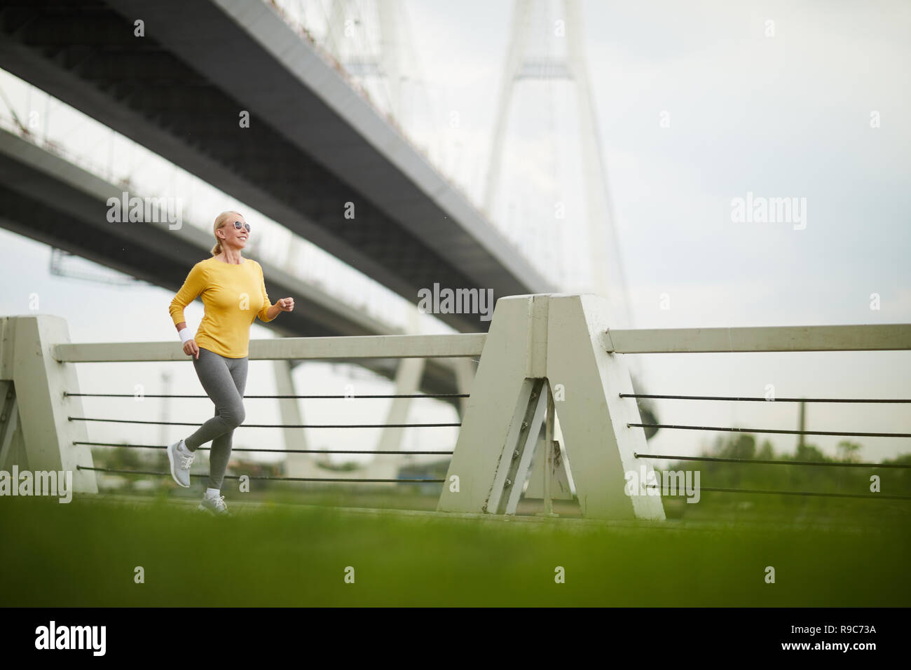 Jogging along riverside Stock Photo - Alamy