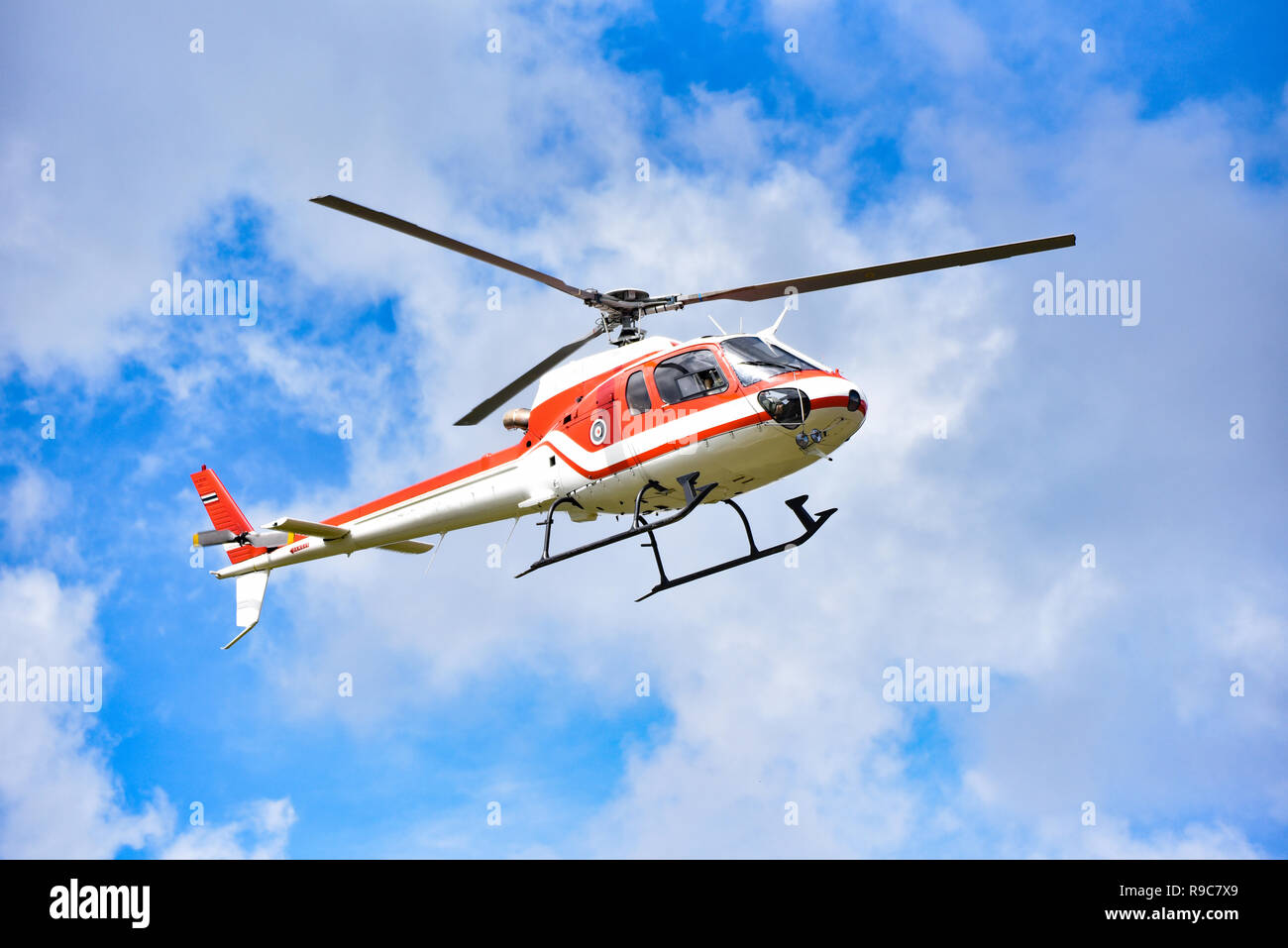 helicopter flying on sky / white red fly helicopter on blue sky with ...