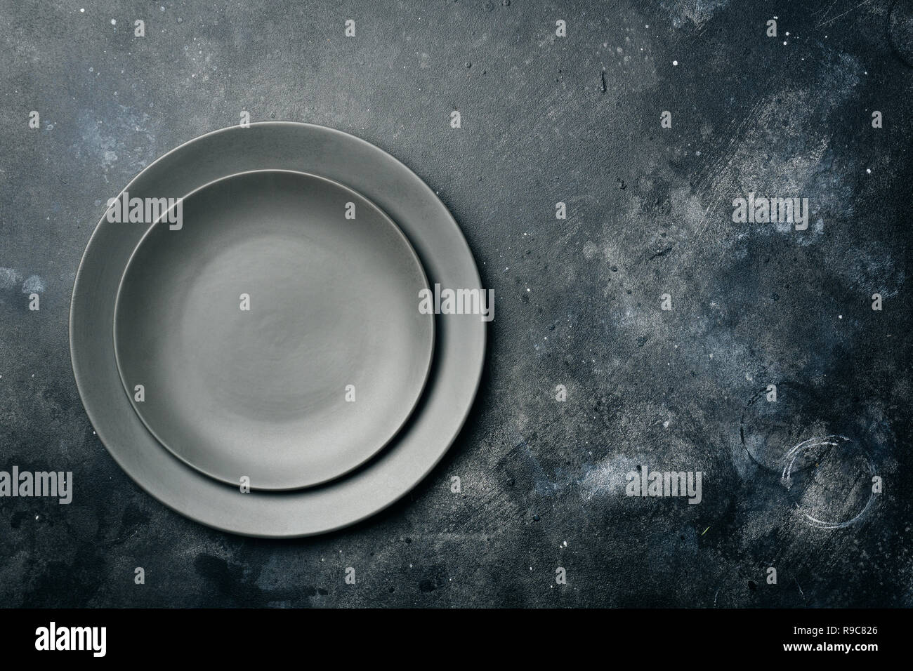 Gray empty plate (ceramic) on a gray stone background. Gray minimalism ...