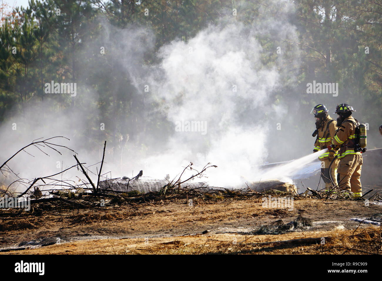 Robins Air Force Base firefighters extinguish fires in the debris field ...