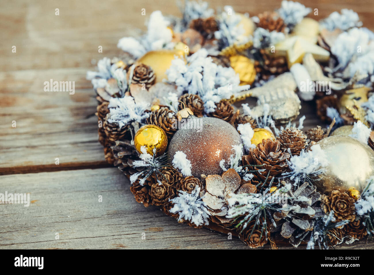 Beautiful hand made golden Christmas wreath decorated with pine cones ...