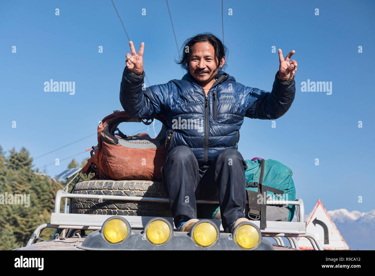 Nepali porter on top of a jeep, Salleri, Nepal Stock Photo - Alamy