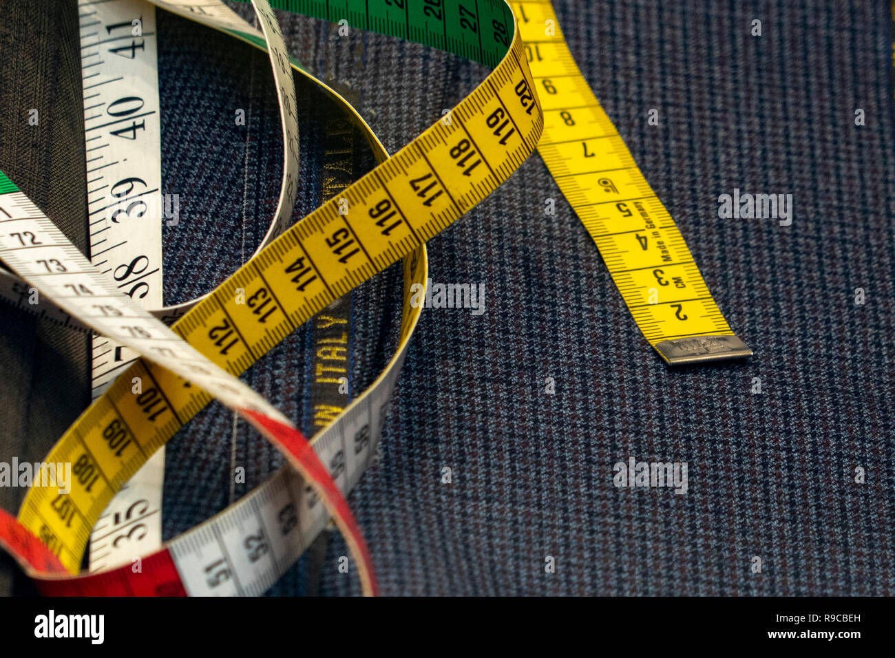 tailor instruments stuff on clothes fabric suits background Stock Photo ...