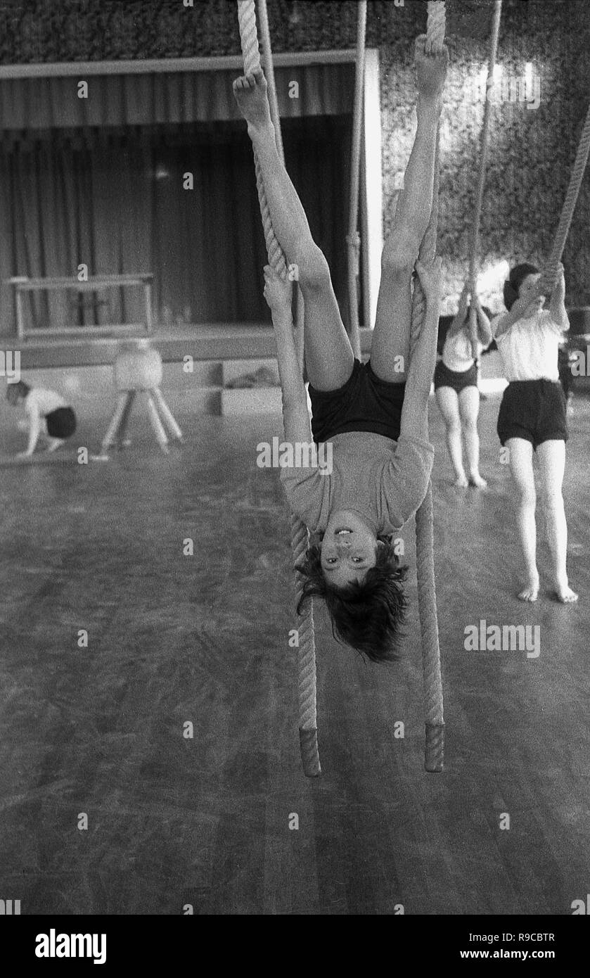 1955, historical, schoolgirls using ropes during a PE class inside a ...