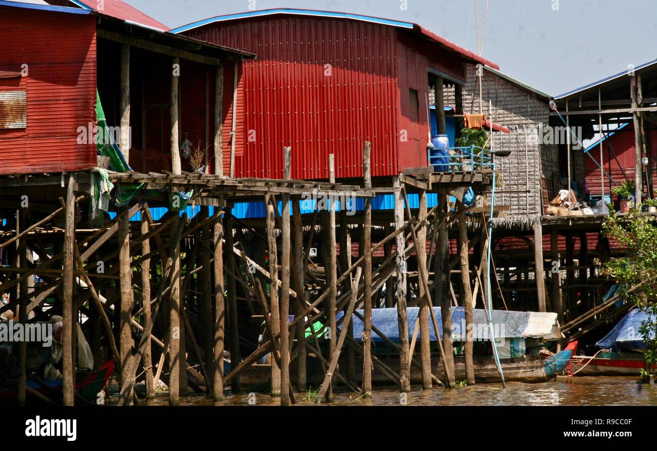 Red stilt homes built over a lake at a floating village in Cambodia ...
