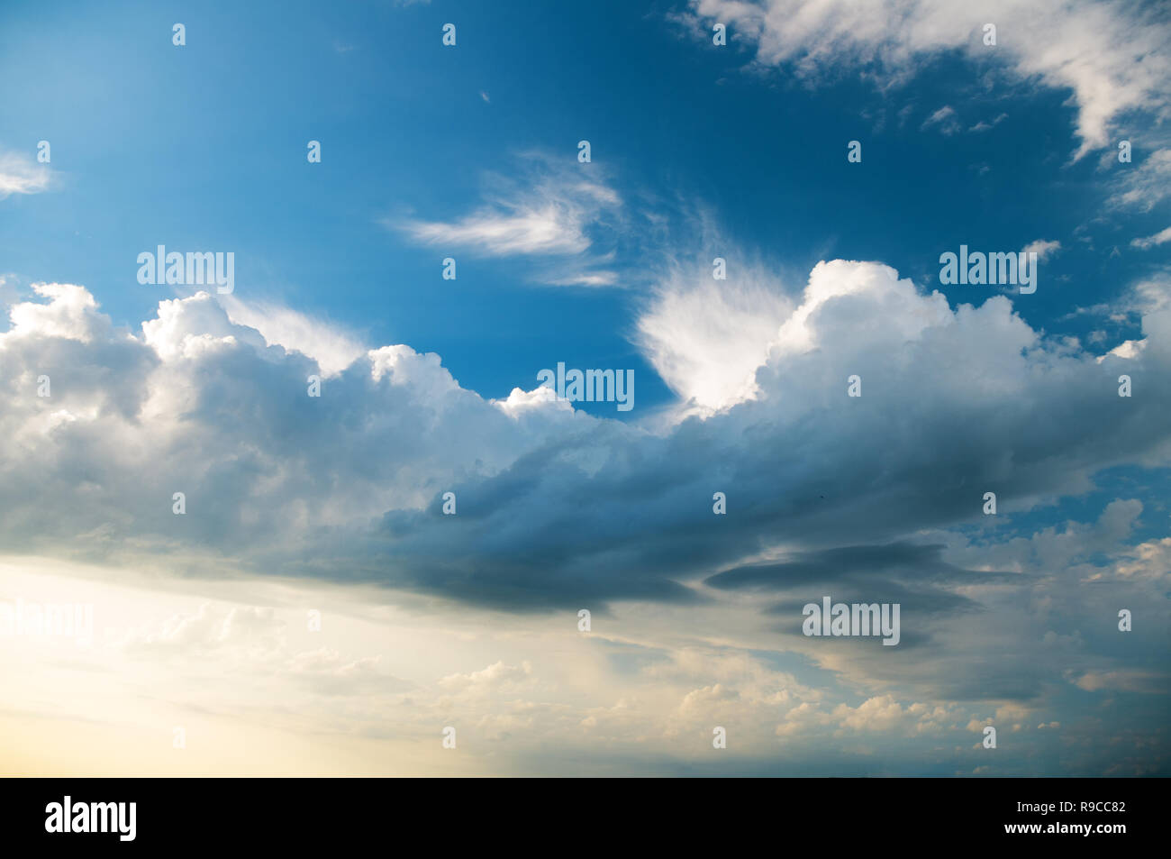 White clouds on the background of a dark stormy sky. Panoramic photo of ...