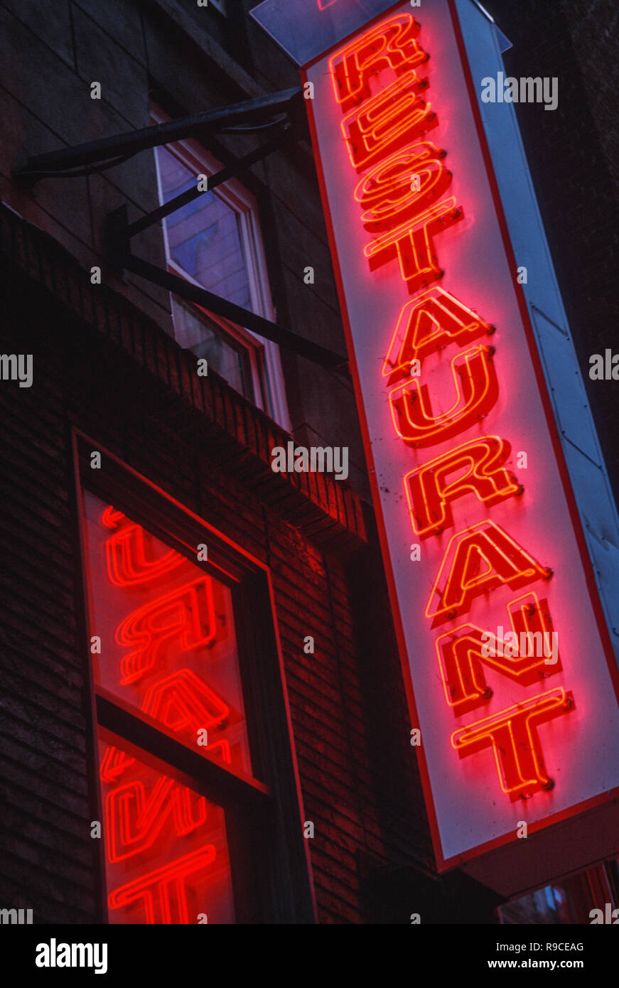 Bright red restaurant neon sign is reflecting in a window, New York ...