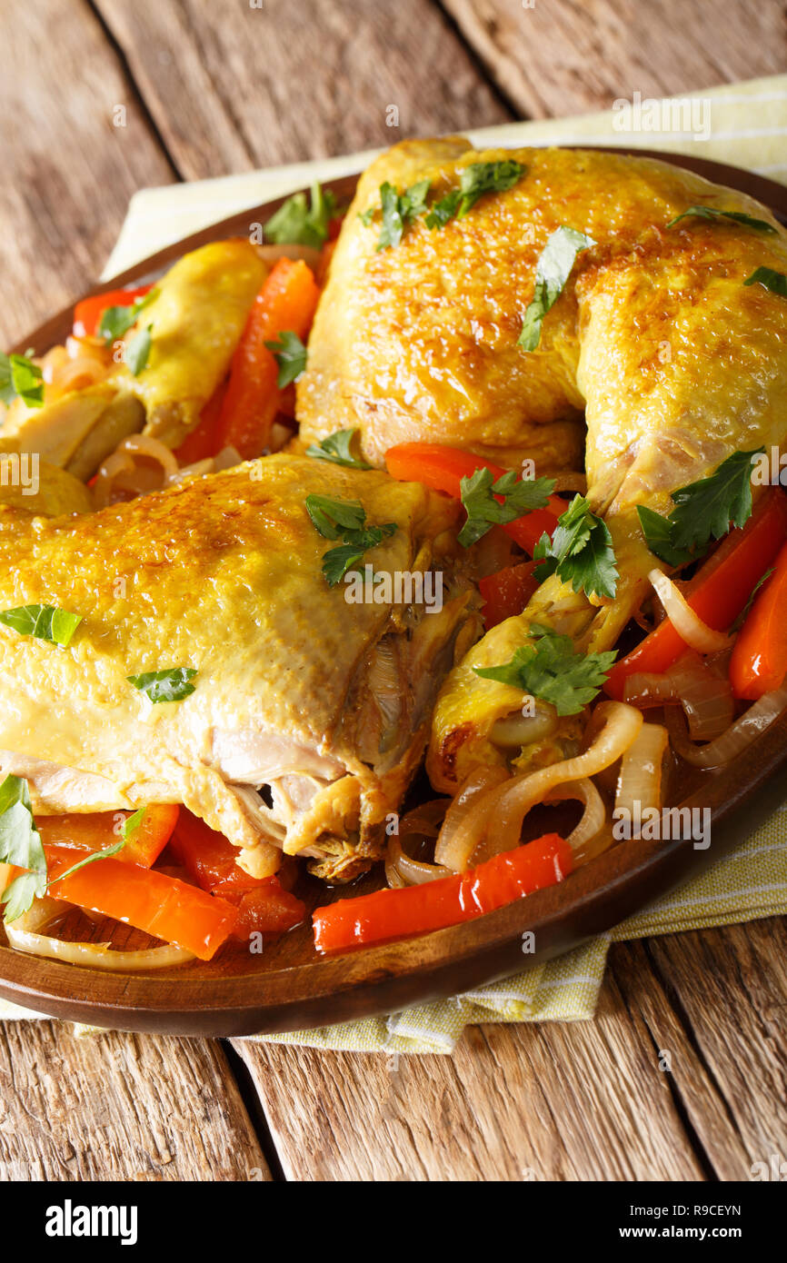 Arab saffron chicken legs served with steamed vegetables close-up on a ...