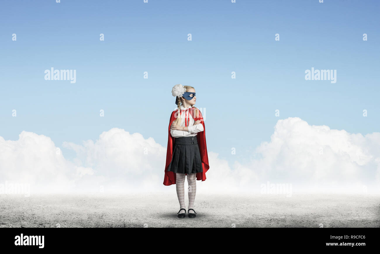 Girl power concept with cute kid guardian against cloudscape bac Stock ...