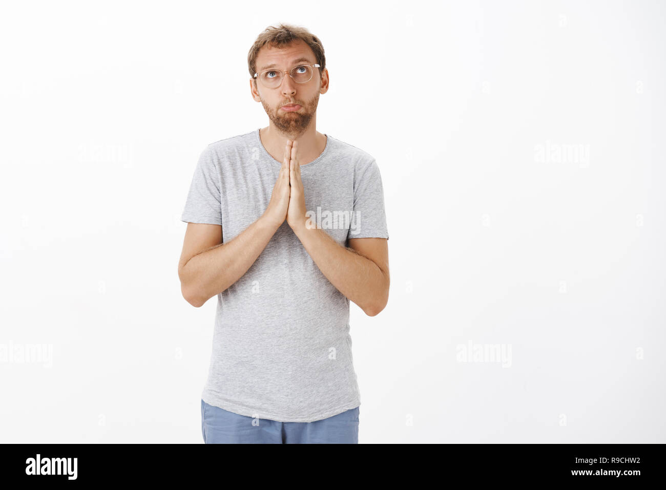 Silly hopeful guy praying god wanting make dream come true holding ...
