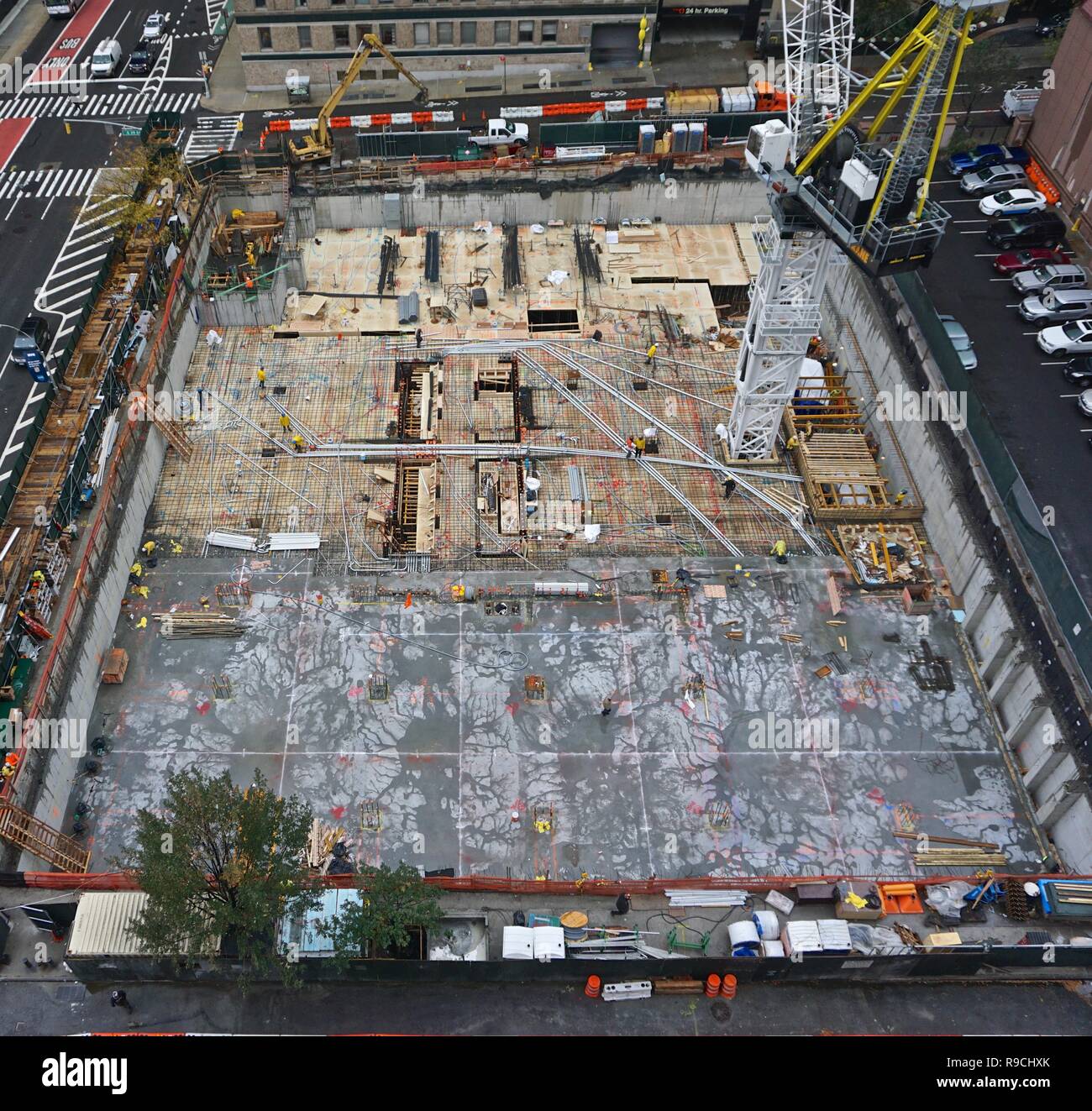 Workers resume tasks after rain dampens the construction site of a new ...