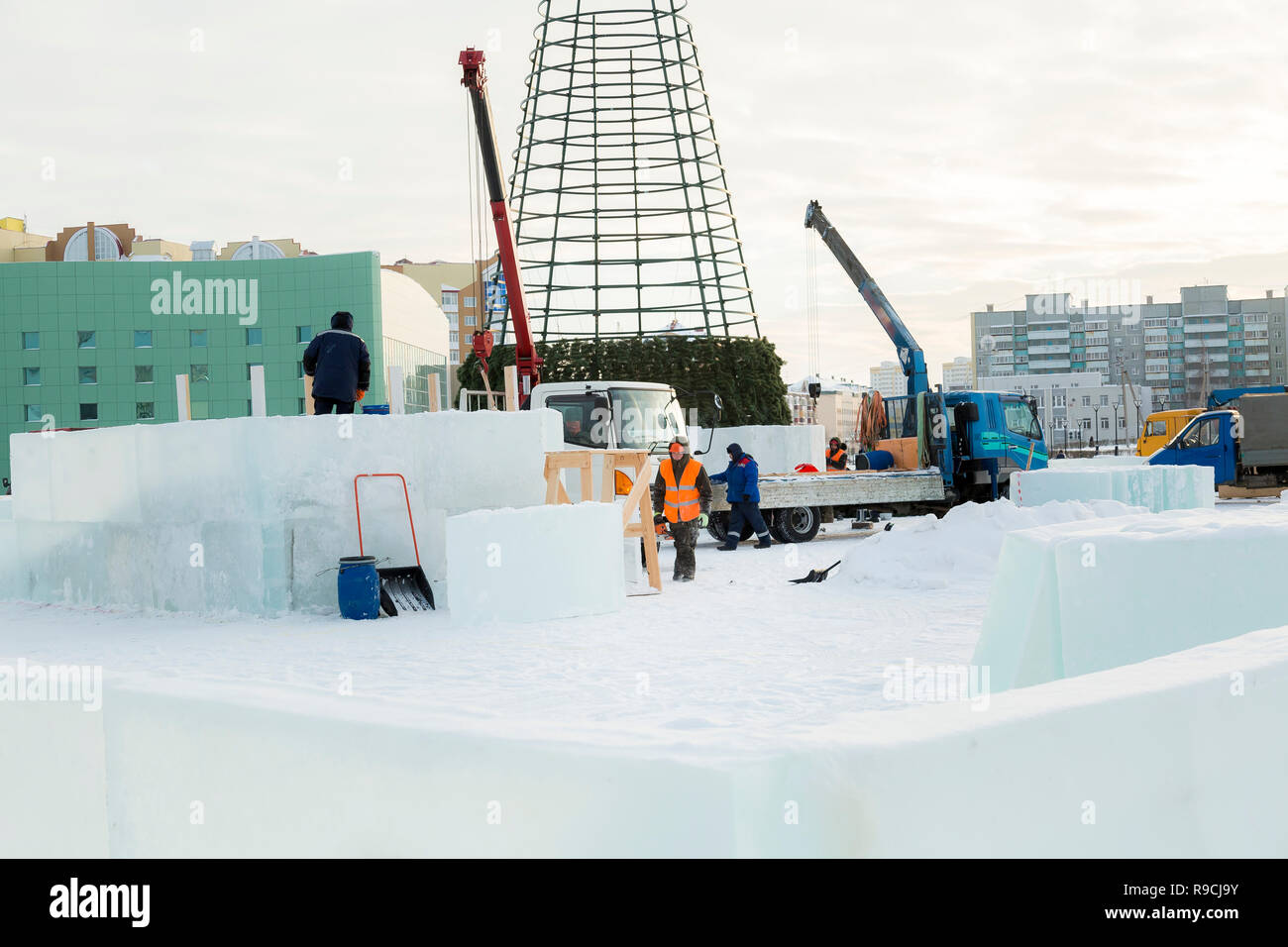 Installers at the construction site are building an ice town for ...