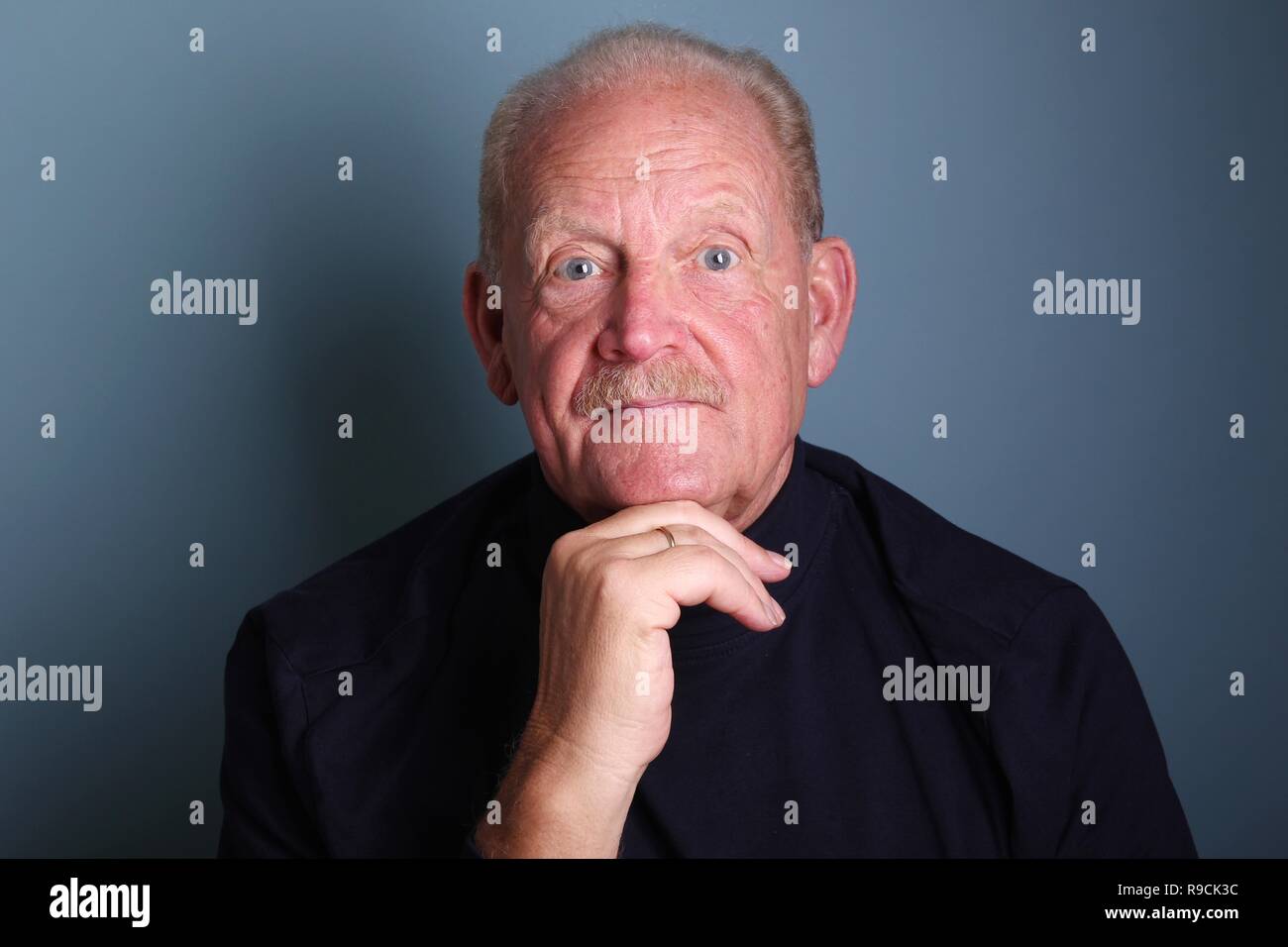 Beautiful old man in front of a background Stock Photo - Alamy