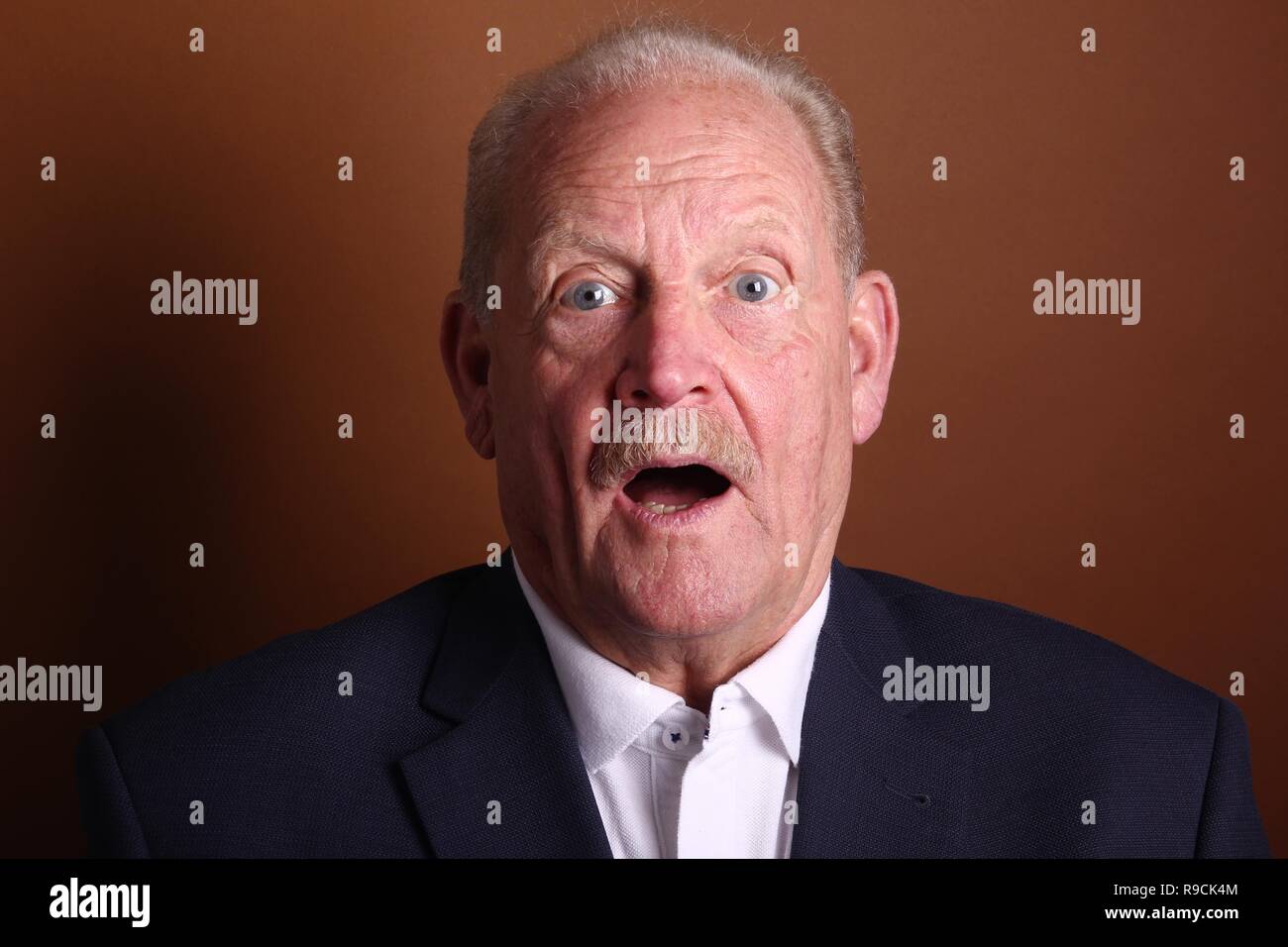 Beautiful old man in front of a background Stock Photo - Alamy