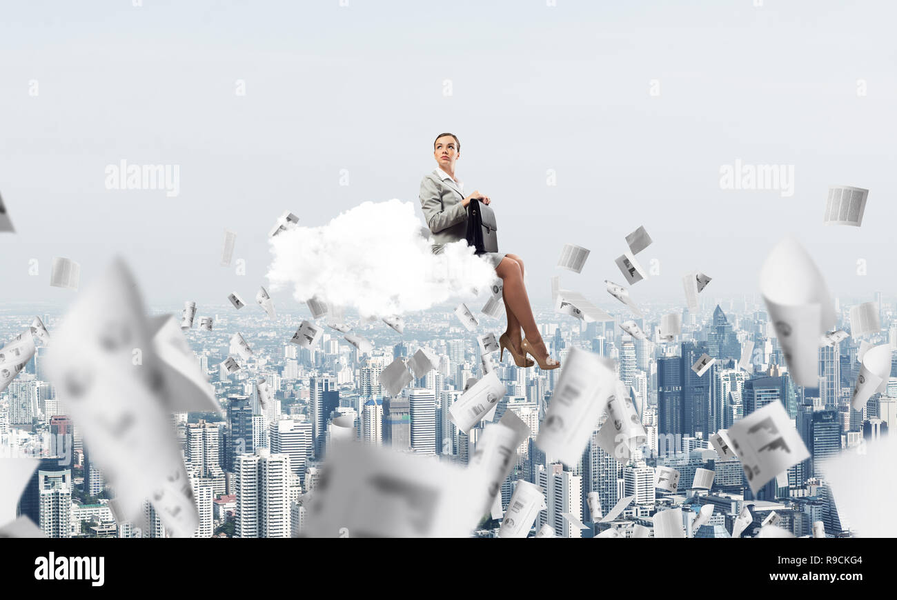 Woman float above city on cloud and papers flying around Stock Photo ...