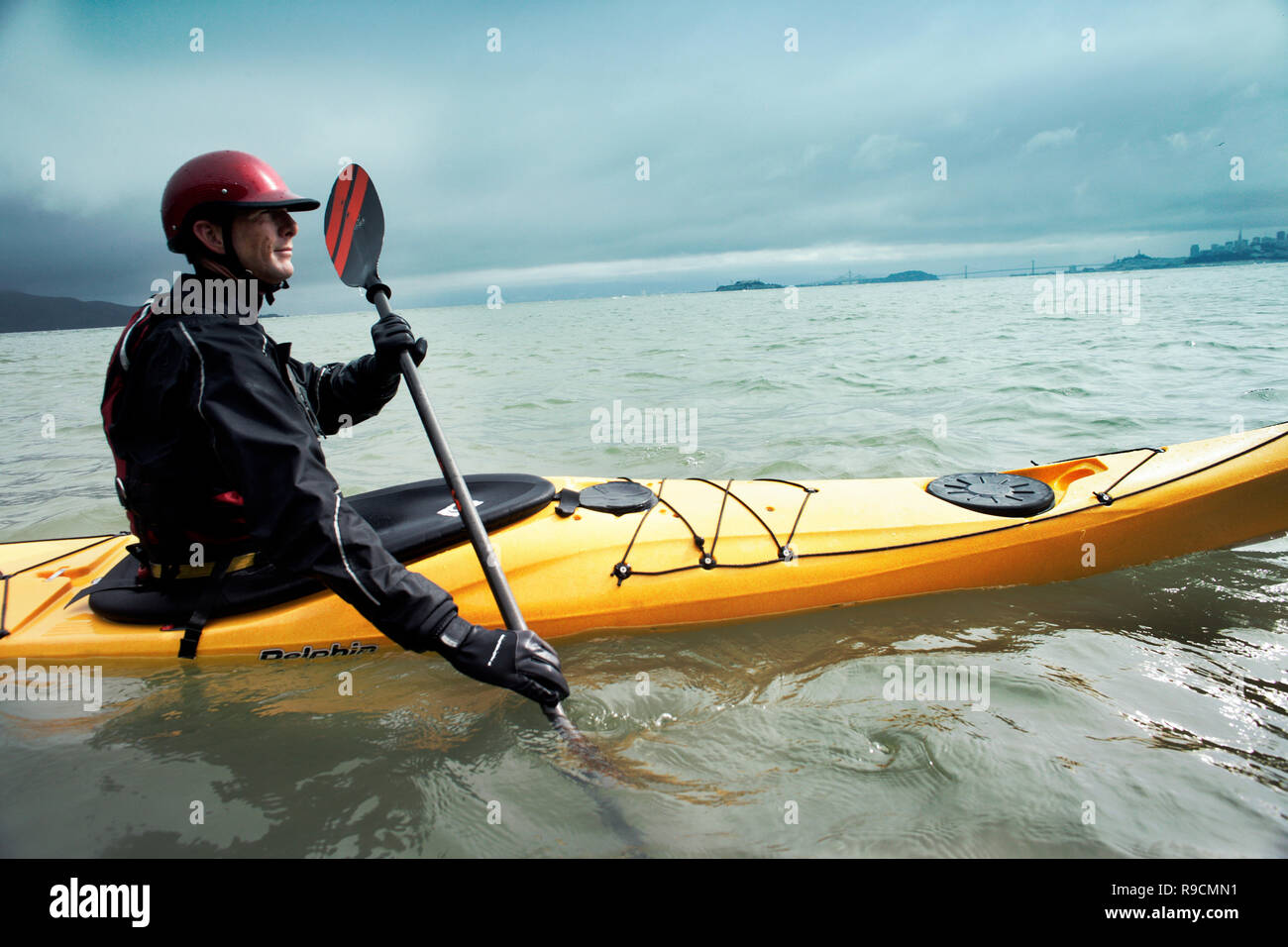 USA, California, San Francisco, individuals endure the cold to kayak ...