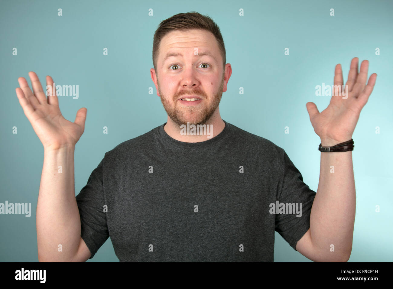 Man leaning forwards staring at the camera in shock, surprise or ...