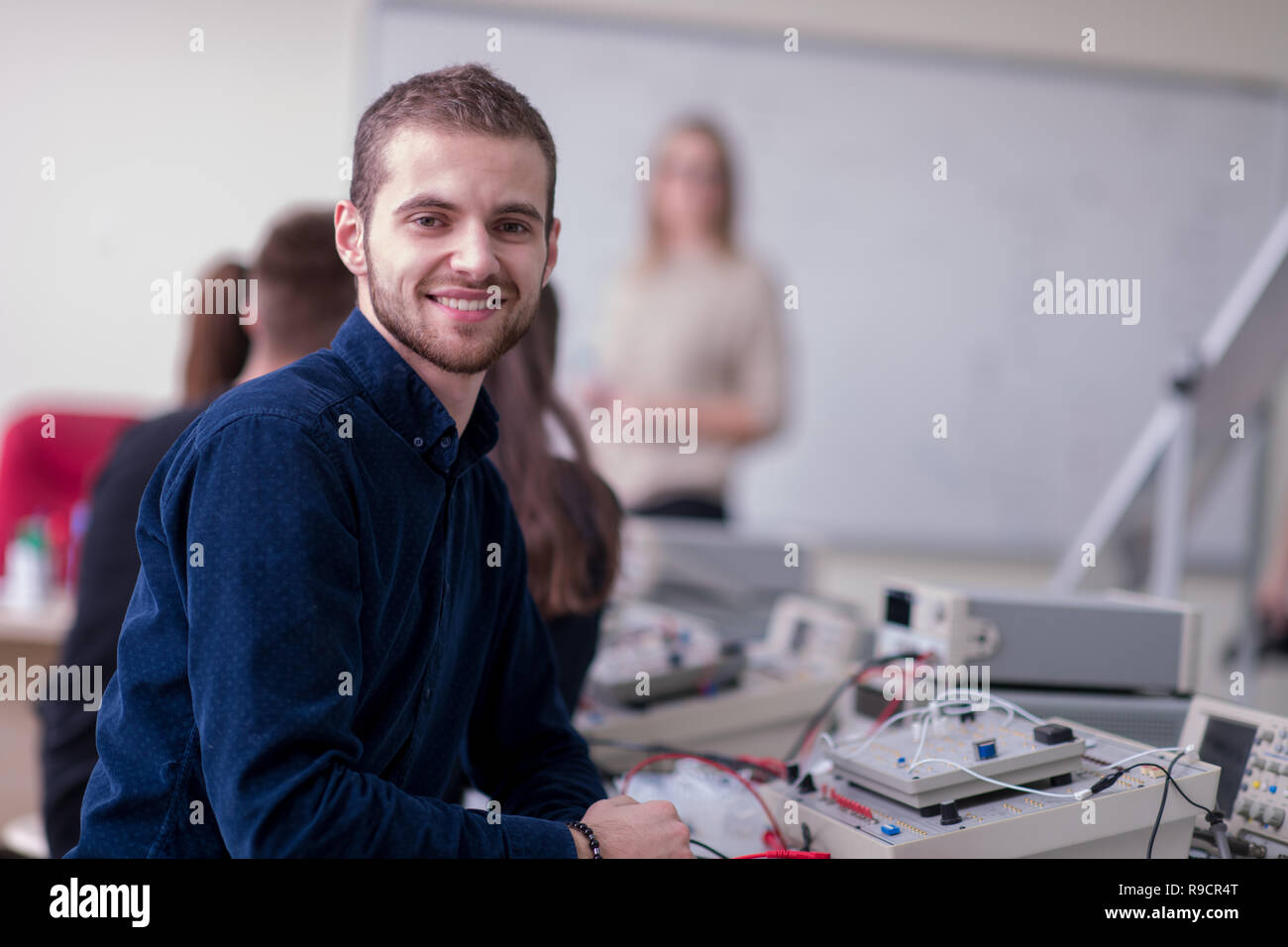 Group of young students doing technical vocational practice with ...