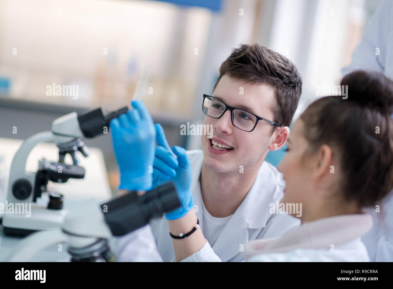 Group of young medical students doing research together in chemistry ...