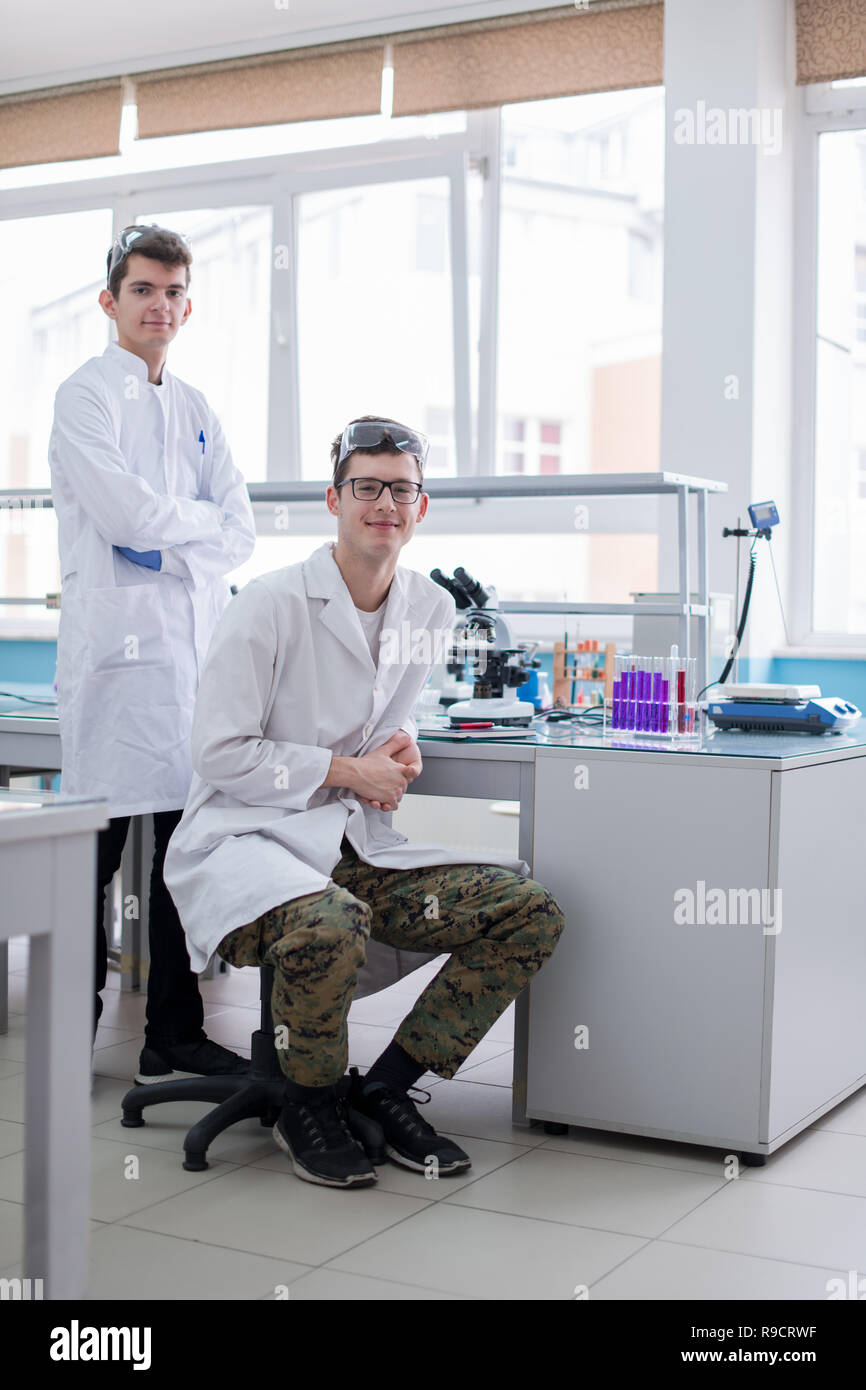 Group of young medical students doing research together in chemistry ...
