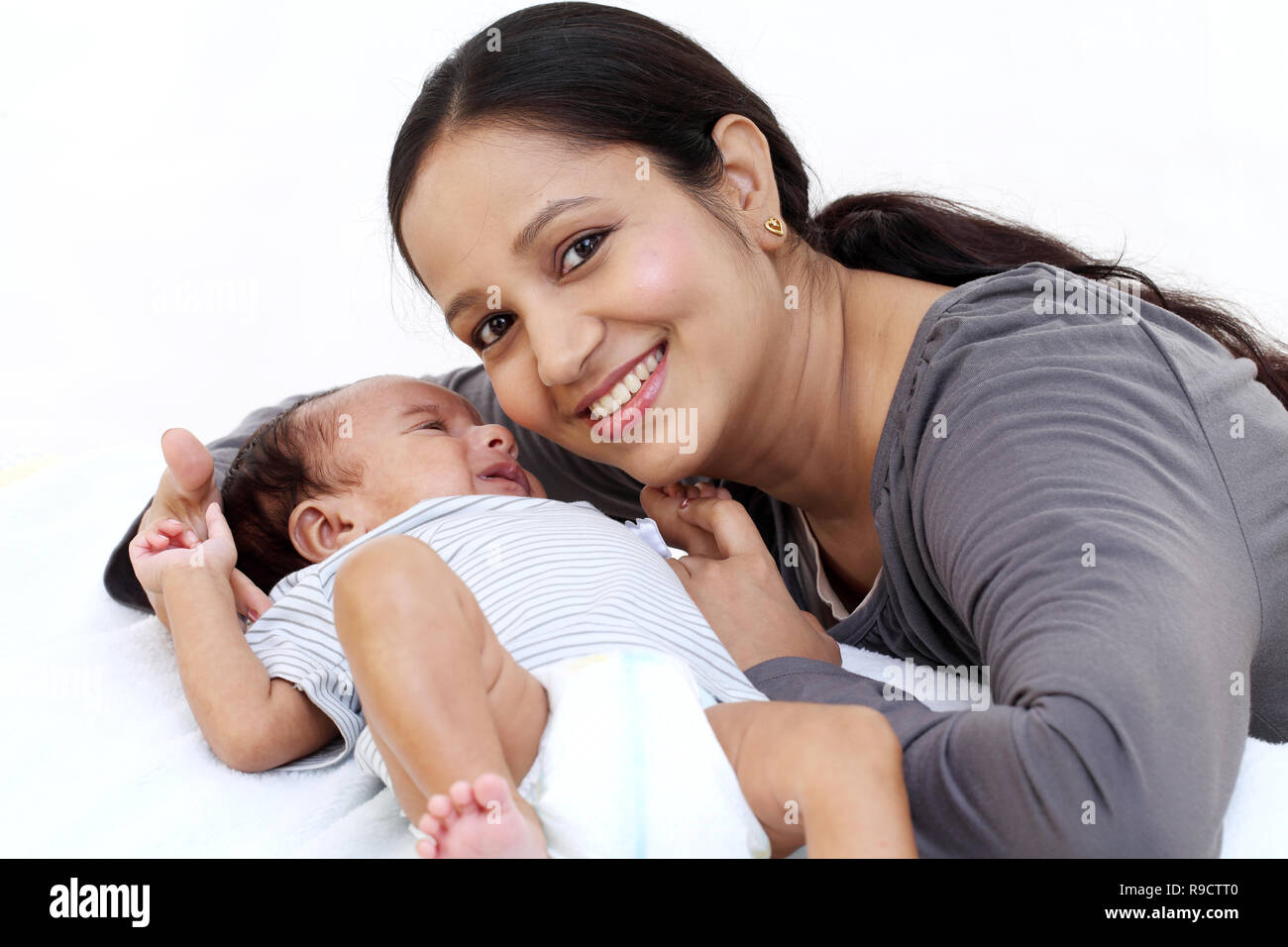 Cheerful mother with newborn baby Stock Photo - Alamy